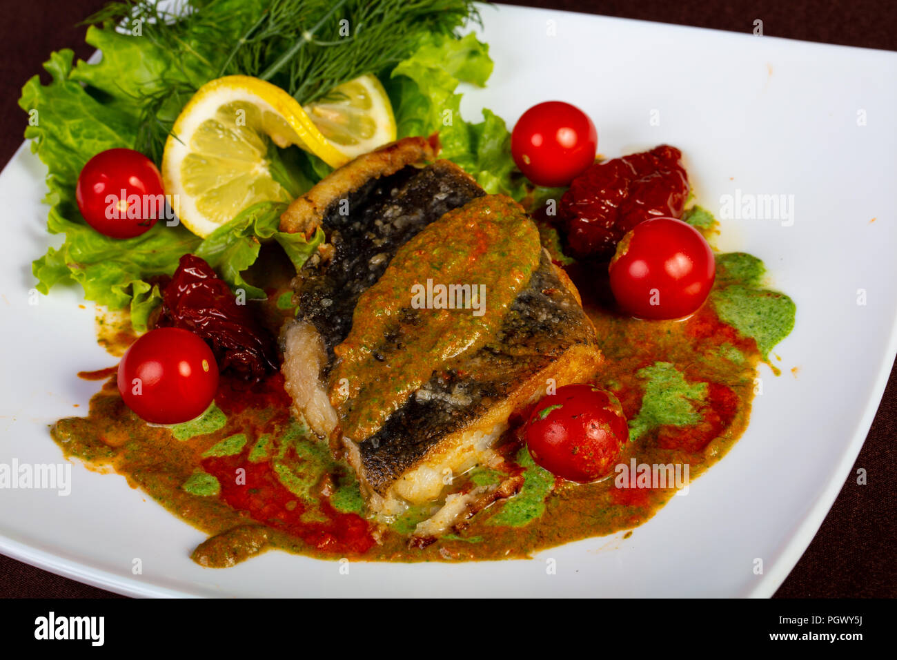 Baked halibut fish fillet with cherry tomato Stock Photo - Alamy