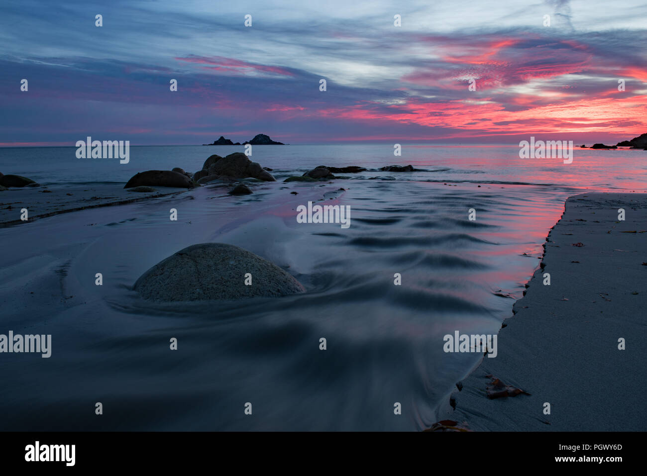 Sunset reflections at the beach Stock Photo - Alamy