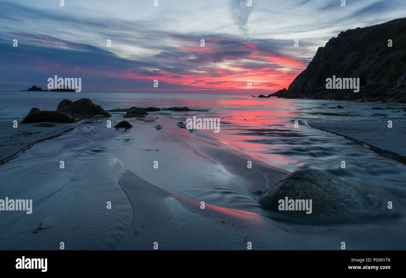 Sunset reflections at the beach Stock Photo - Alamy