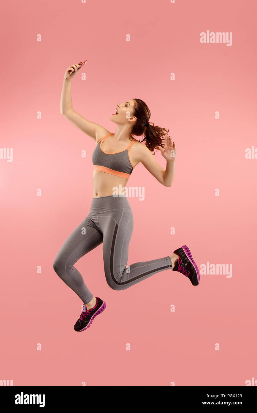 always on mobile. Full length of pretty young woman taking phone while ...