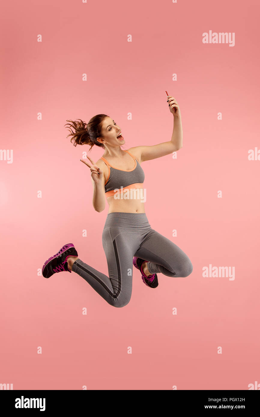 always on mobile. Full length of pretty young woman taking phone while ...