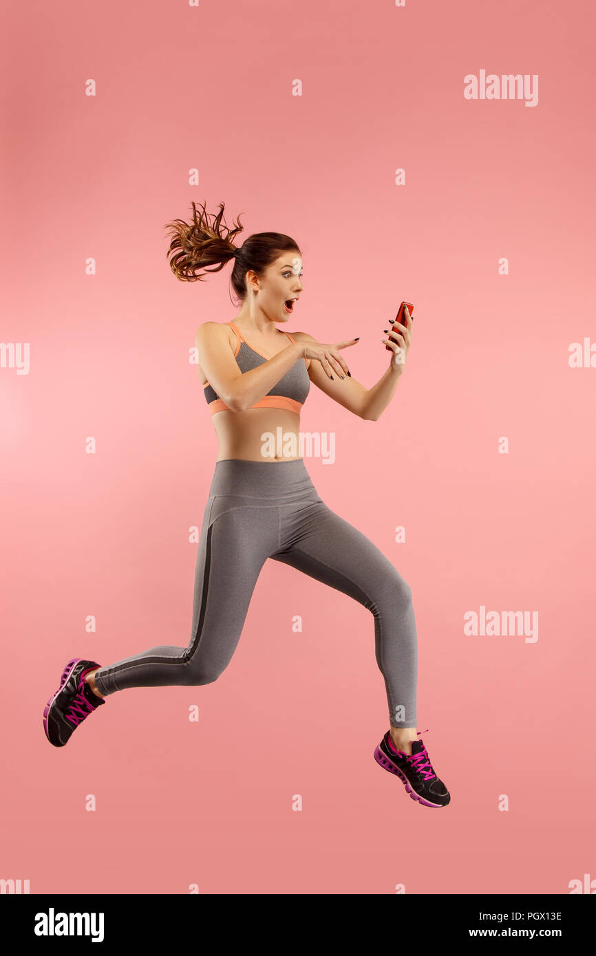 always on mobile. Full length of pretty young woman taking phone while ...