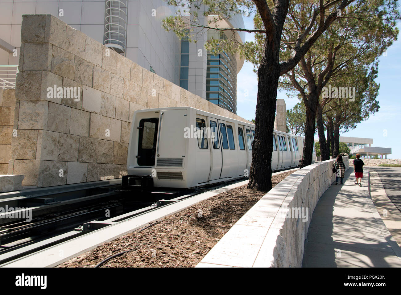 A view of an elevated tram rail and a highway passing cars in Los ...