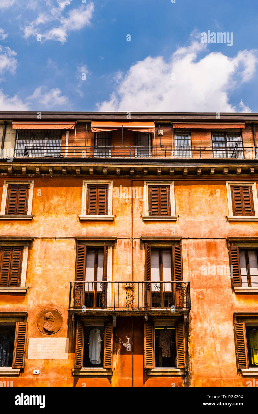 Bright orange render to building facade in Verona, Italy Stock Photo ...