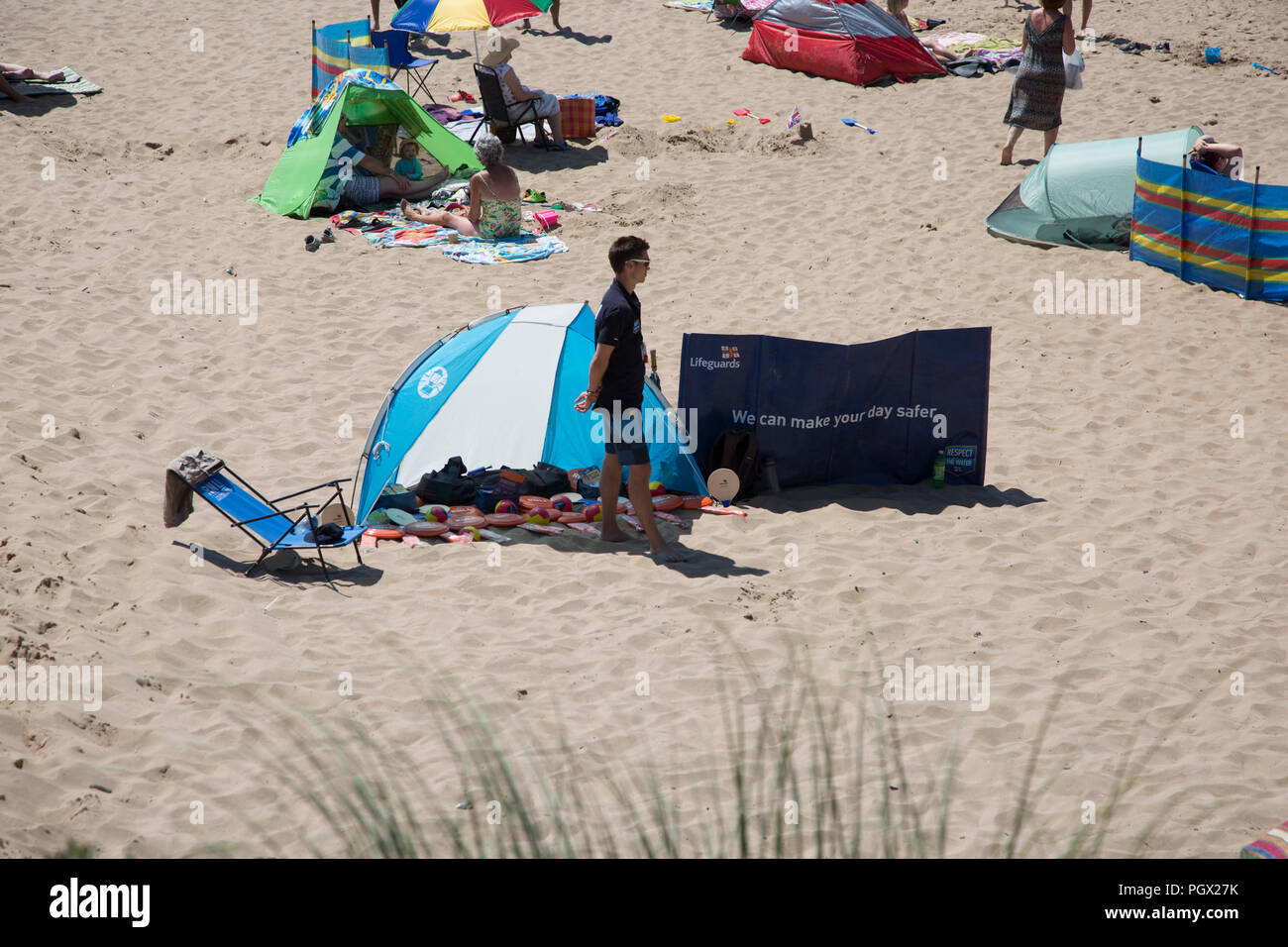 People enjoying Woolacombe Beach in North Devon in the summer sun in ...