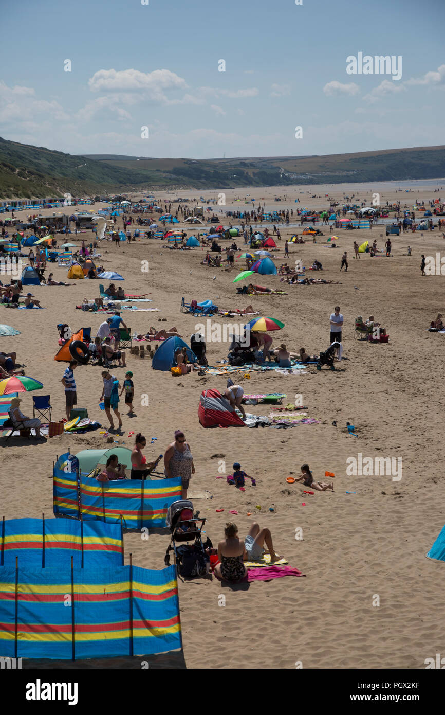 People enjoying Woolacombe Beach in North Devon in the summer sun in ...