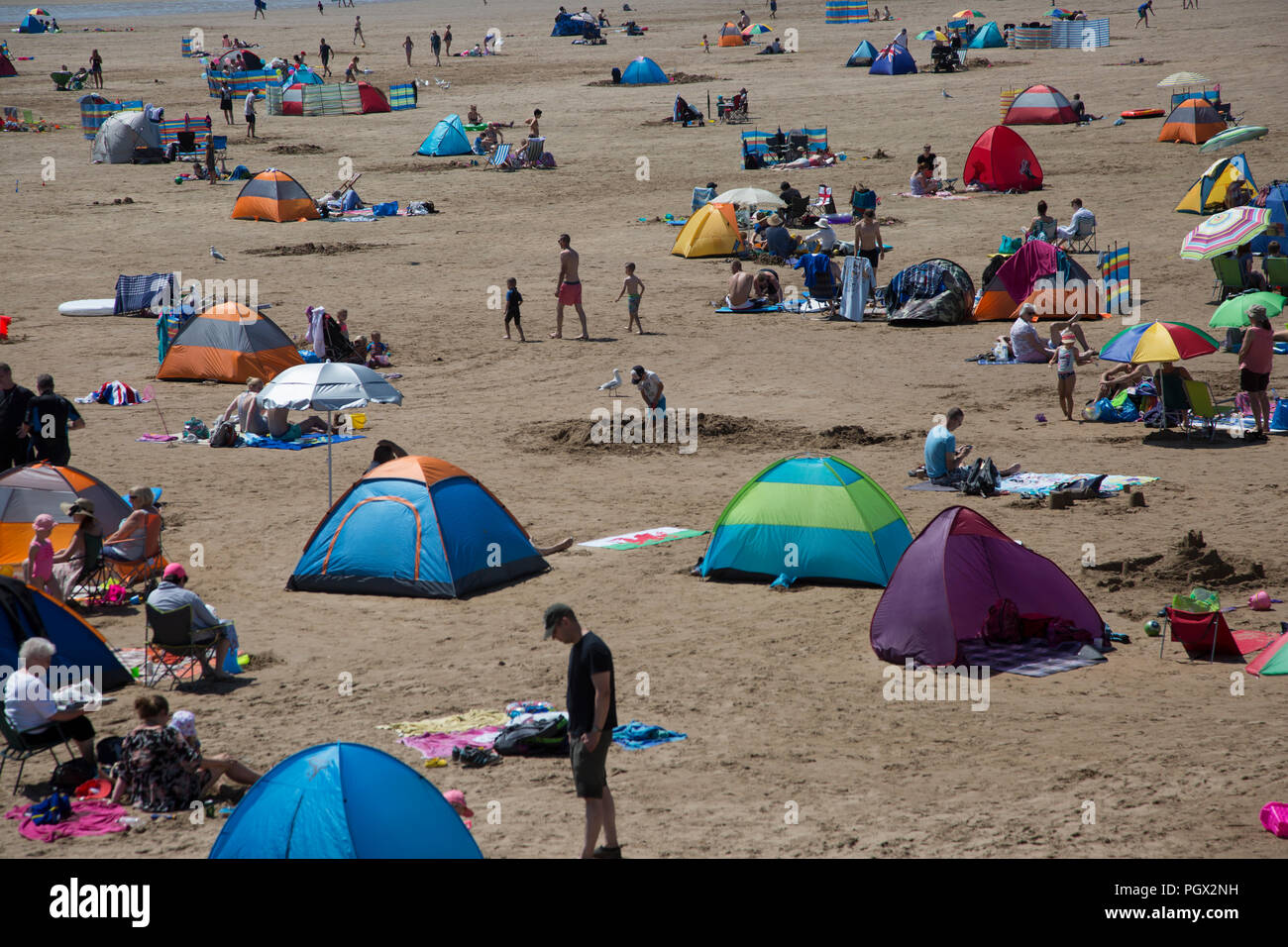 People enjoying Woolacombe Beach in North Devon in the summer sun in ...