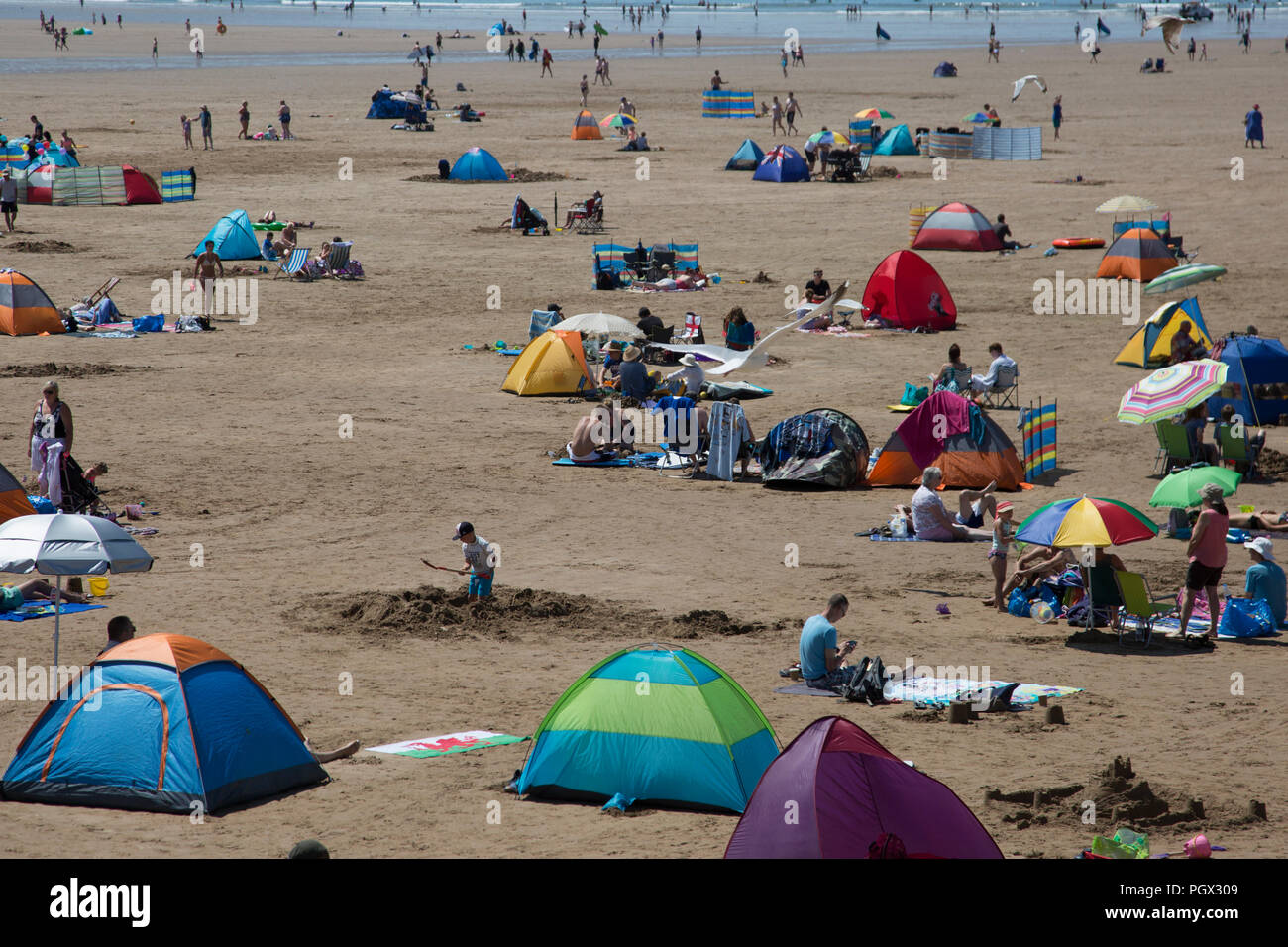 People enjoying Woolacombe Beach in North Devon in the summer sun in ...