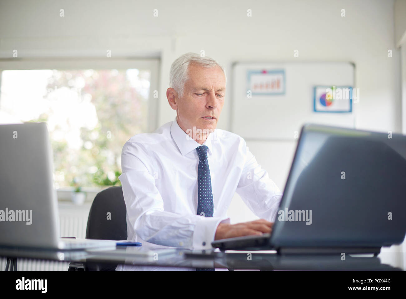 Confident businessman using his laptops while working in the office ...