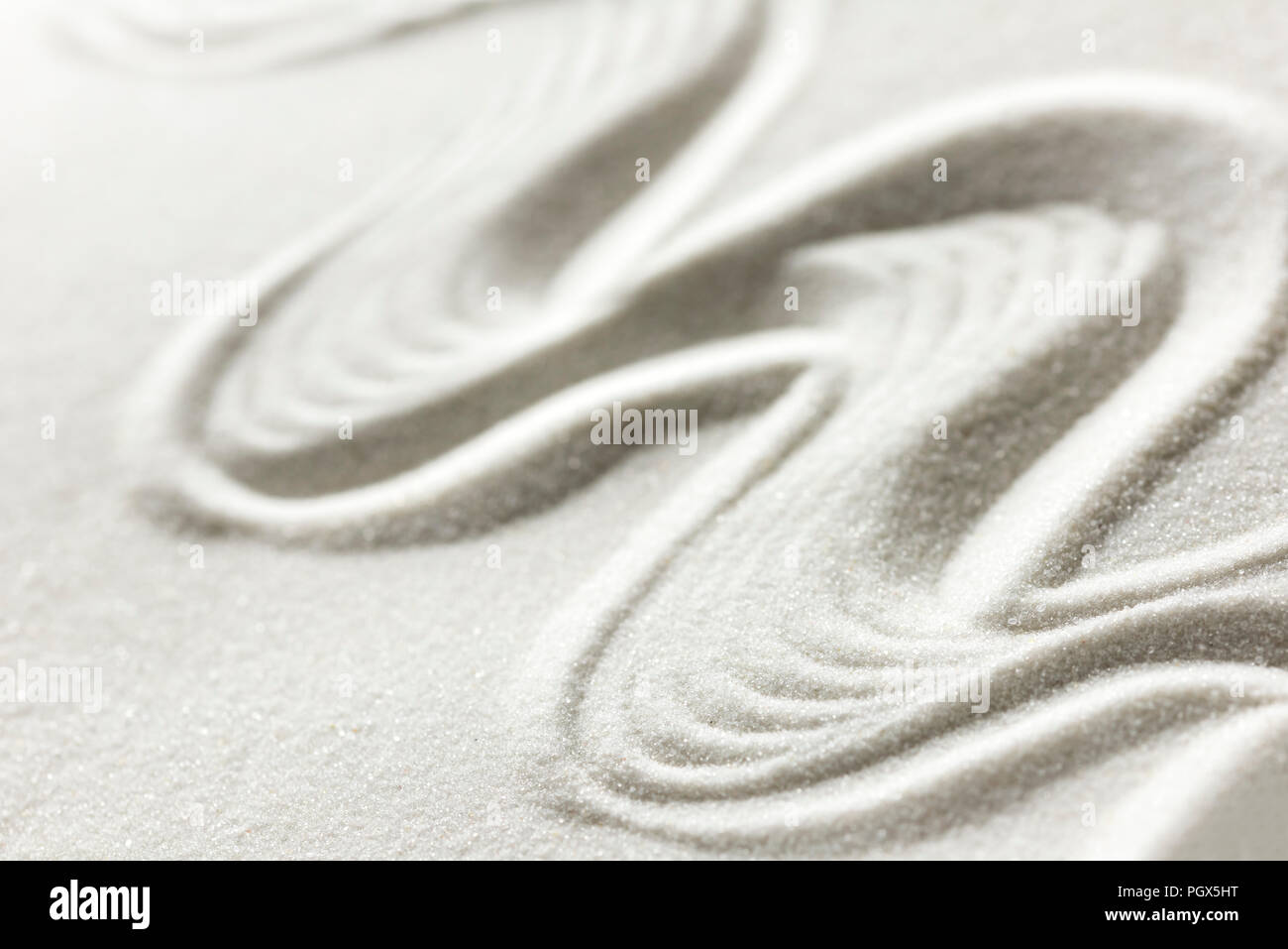 Wavy line draw in the sand of a tropical beach or zen garden with a ...