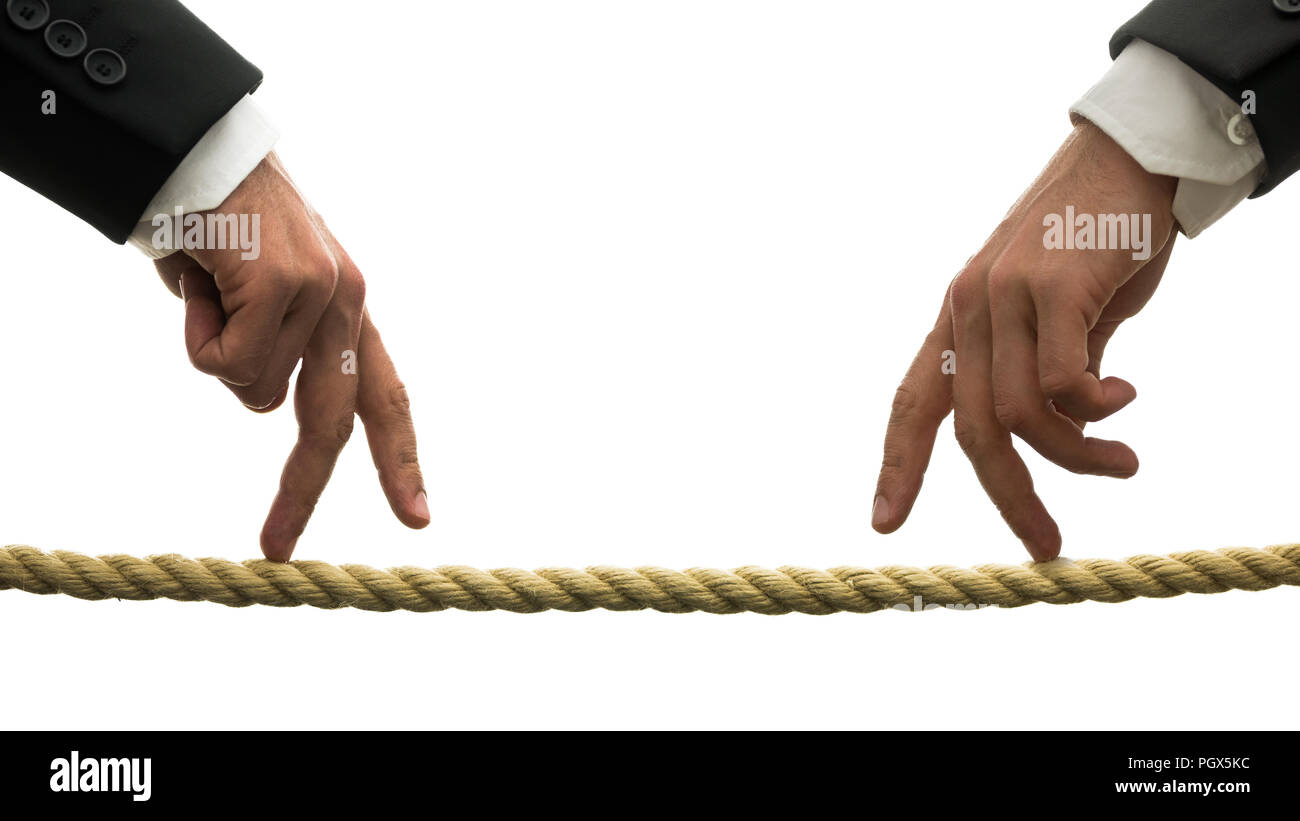 Conceptual image of walking a business tightrope with the hands of two ...