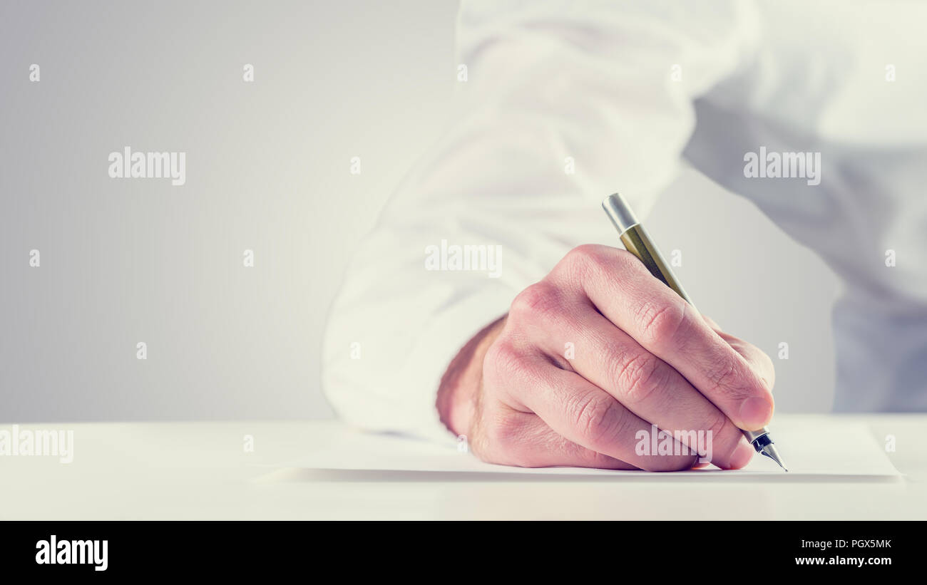 Vintage retro style image of a man signing a document or writing notes ...