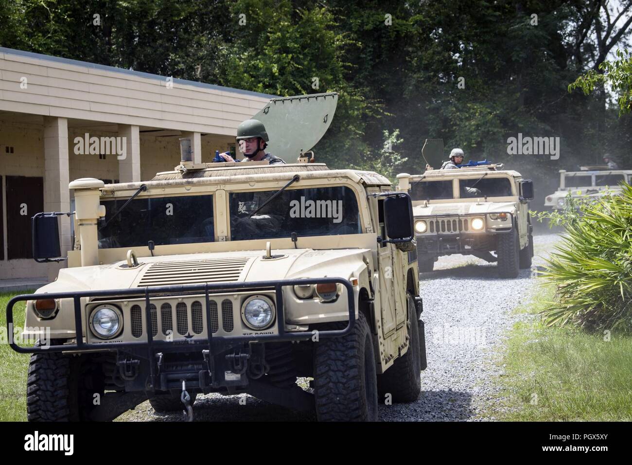 Airmen from the 23d Civil Engineer Squadron (CES) ride in Humvees ...