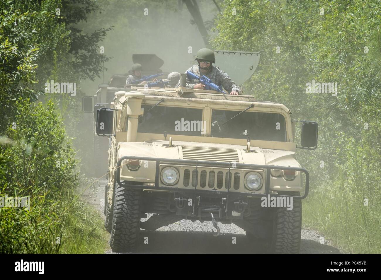 Airmen from the 23d Civil Engineer Squadron (CES) ride in Humvees ...