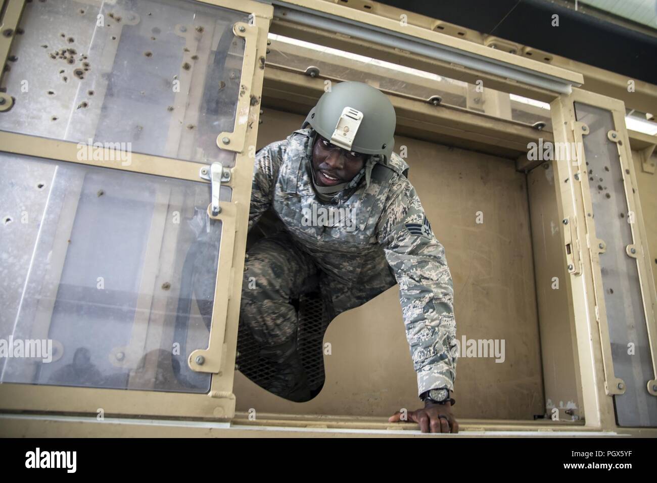 An Airman from the 23d Civil Engineer Squadron (CES), climbs out of a ...