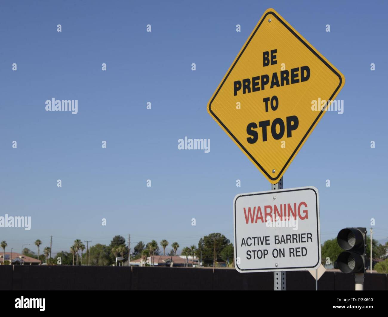 A sign warns drivers to stop for active barriers at a gate on Nellis ...