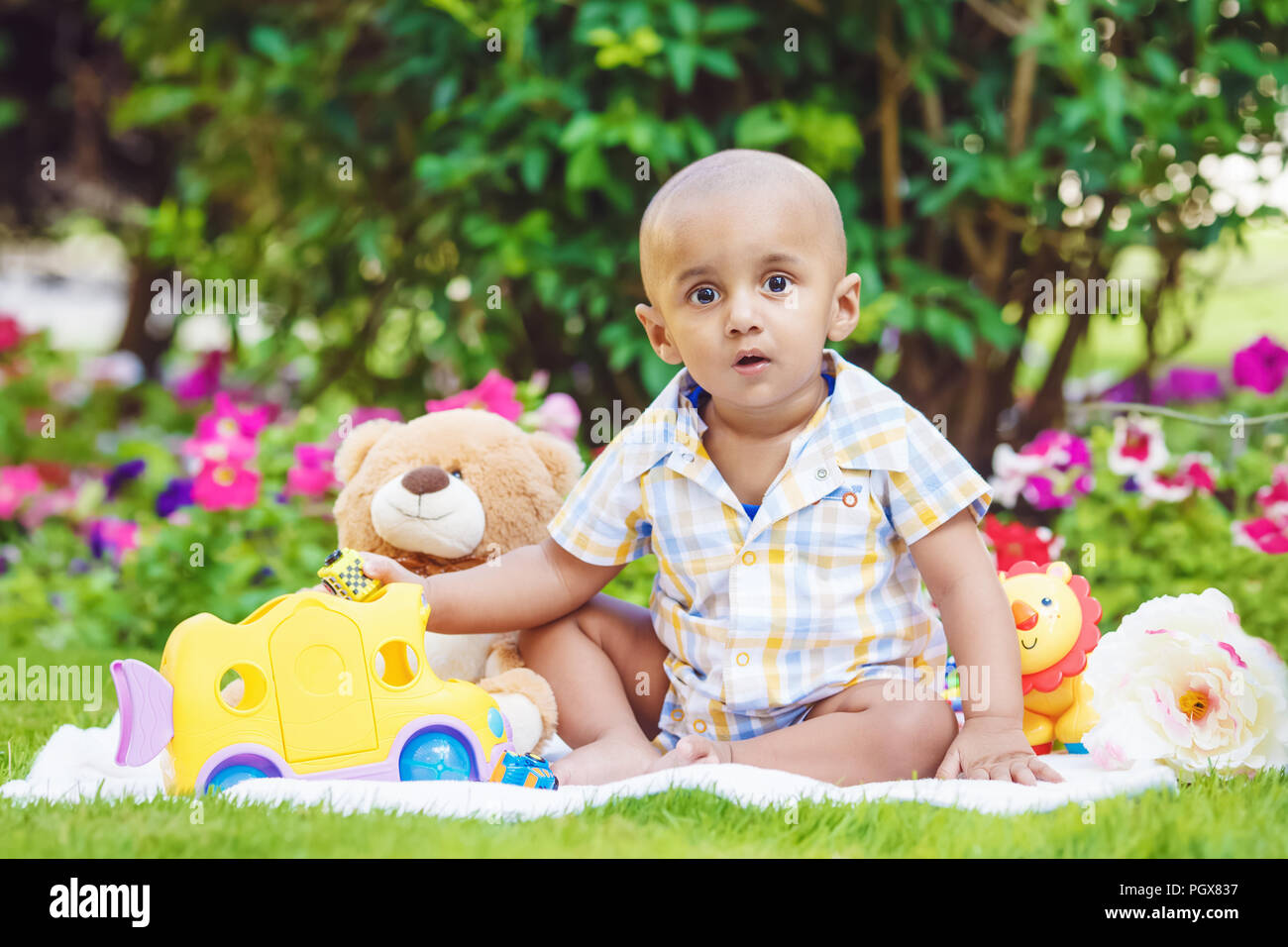 Portrait of cute adorable little indian mixed race infant boy in plaid ...