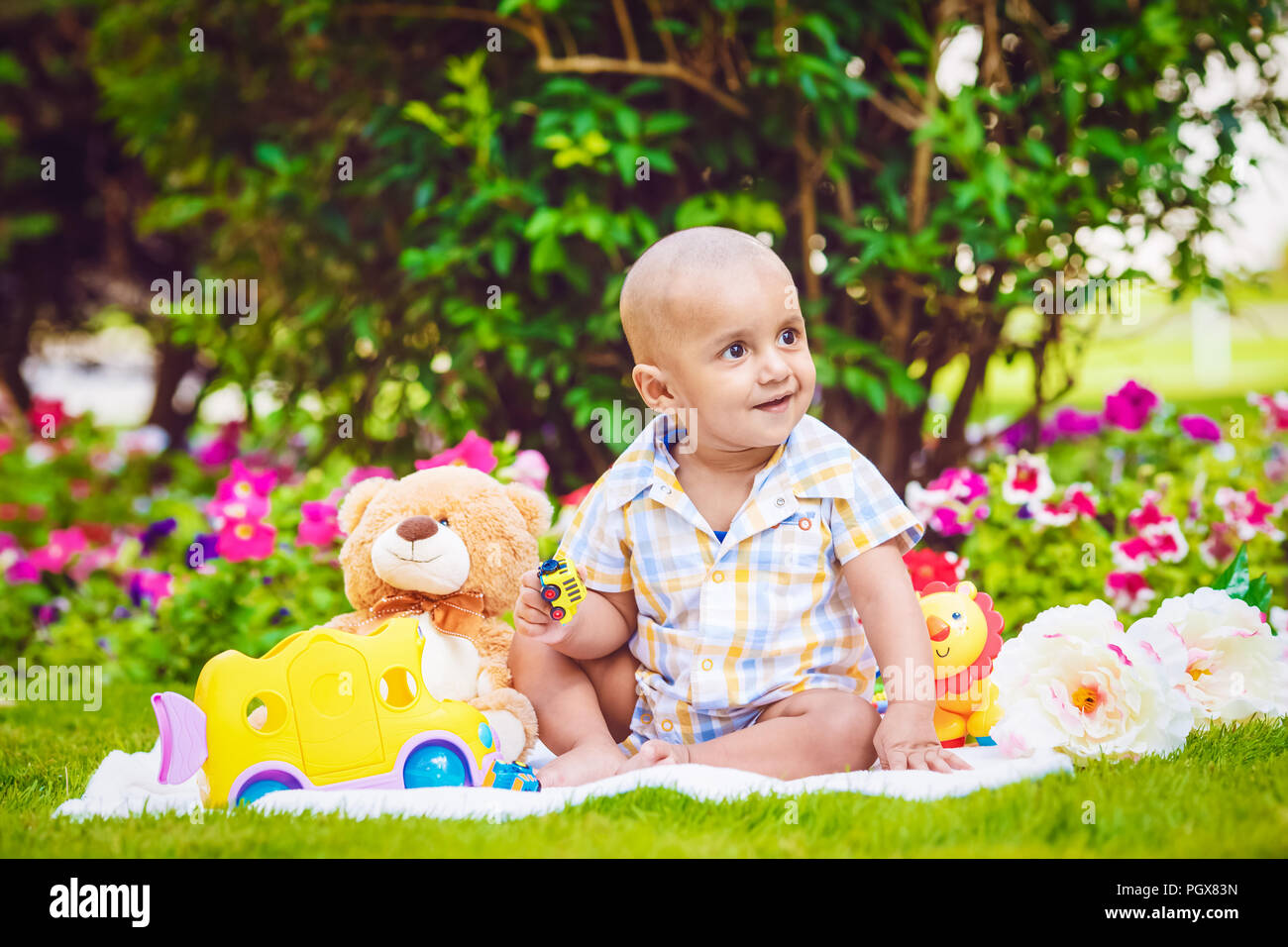 Portrait of cute adorable little indian mixed race infant boy in plaid ...