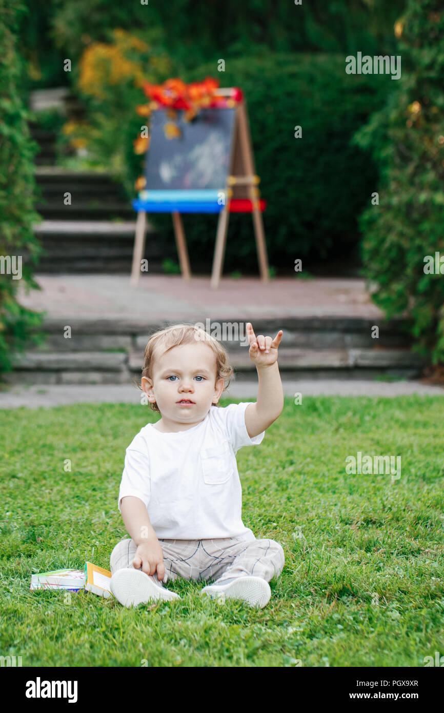 Portrait of funny white Caucasian toddler child kid boy sitting on ...
