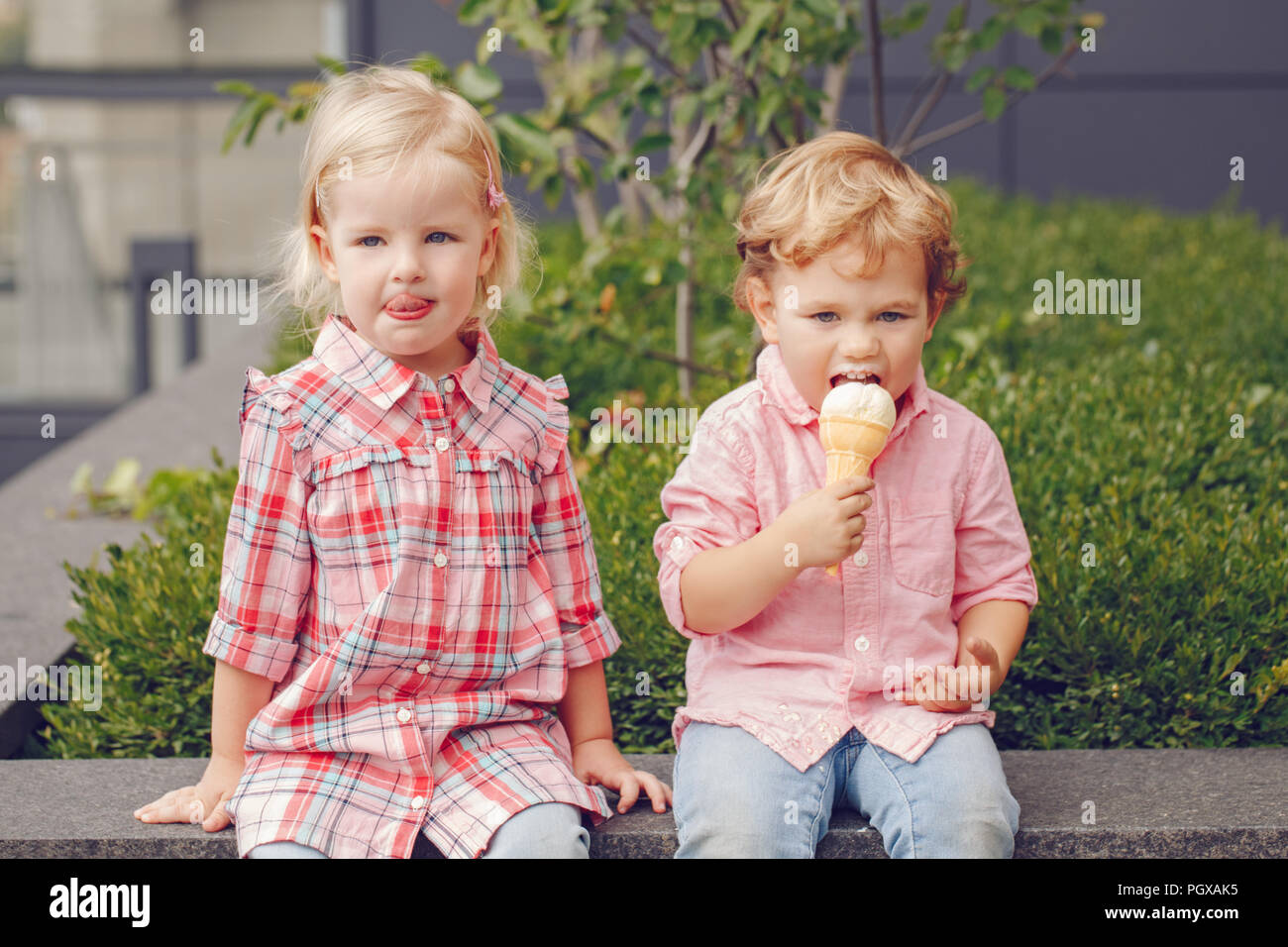 Two children sharing ice cream hi-res stock photography and images - Alamy