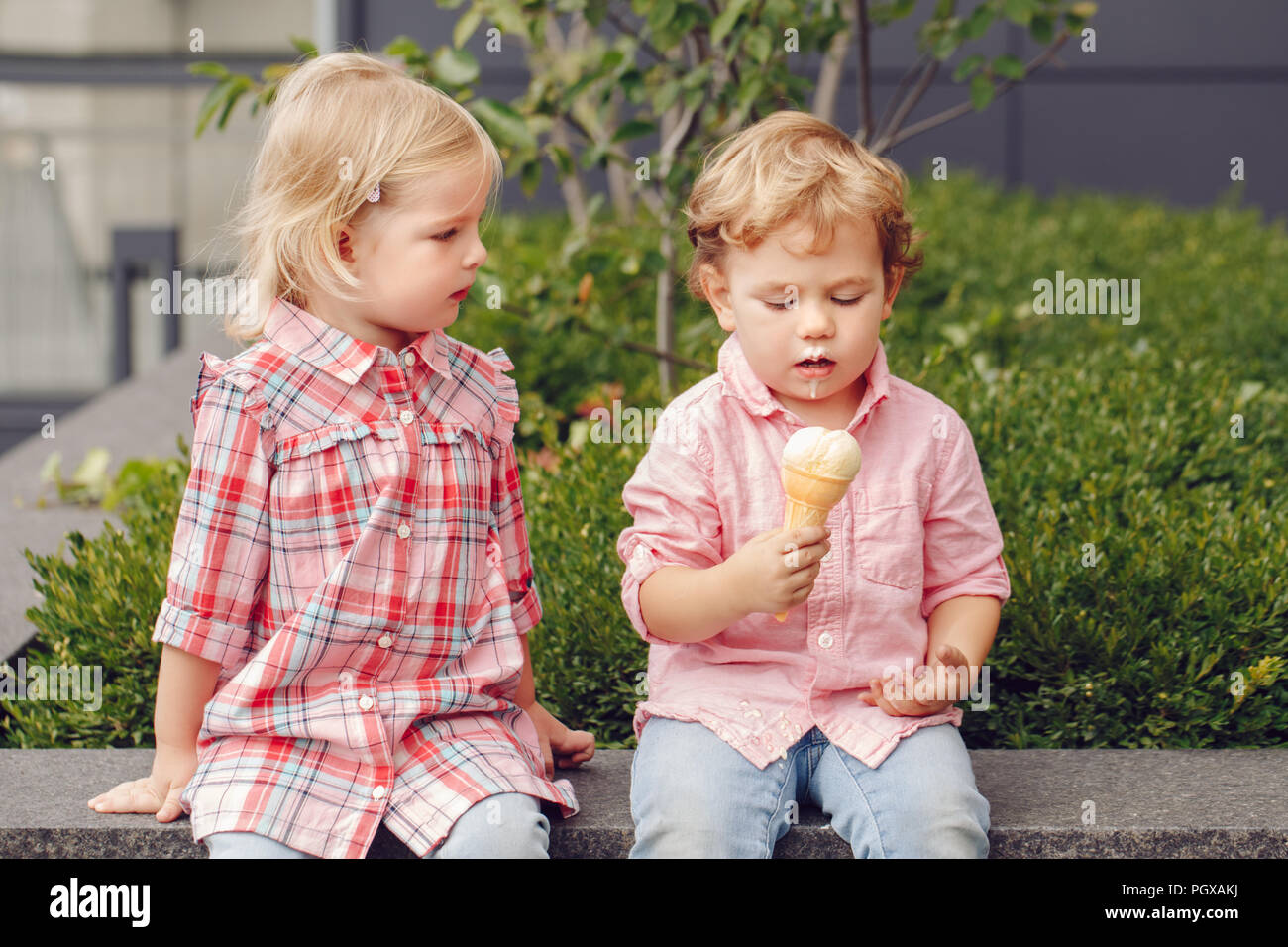 Two children sharing ice cream hi-res stock photography and images - Alamy