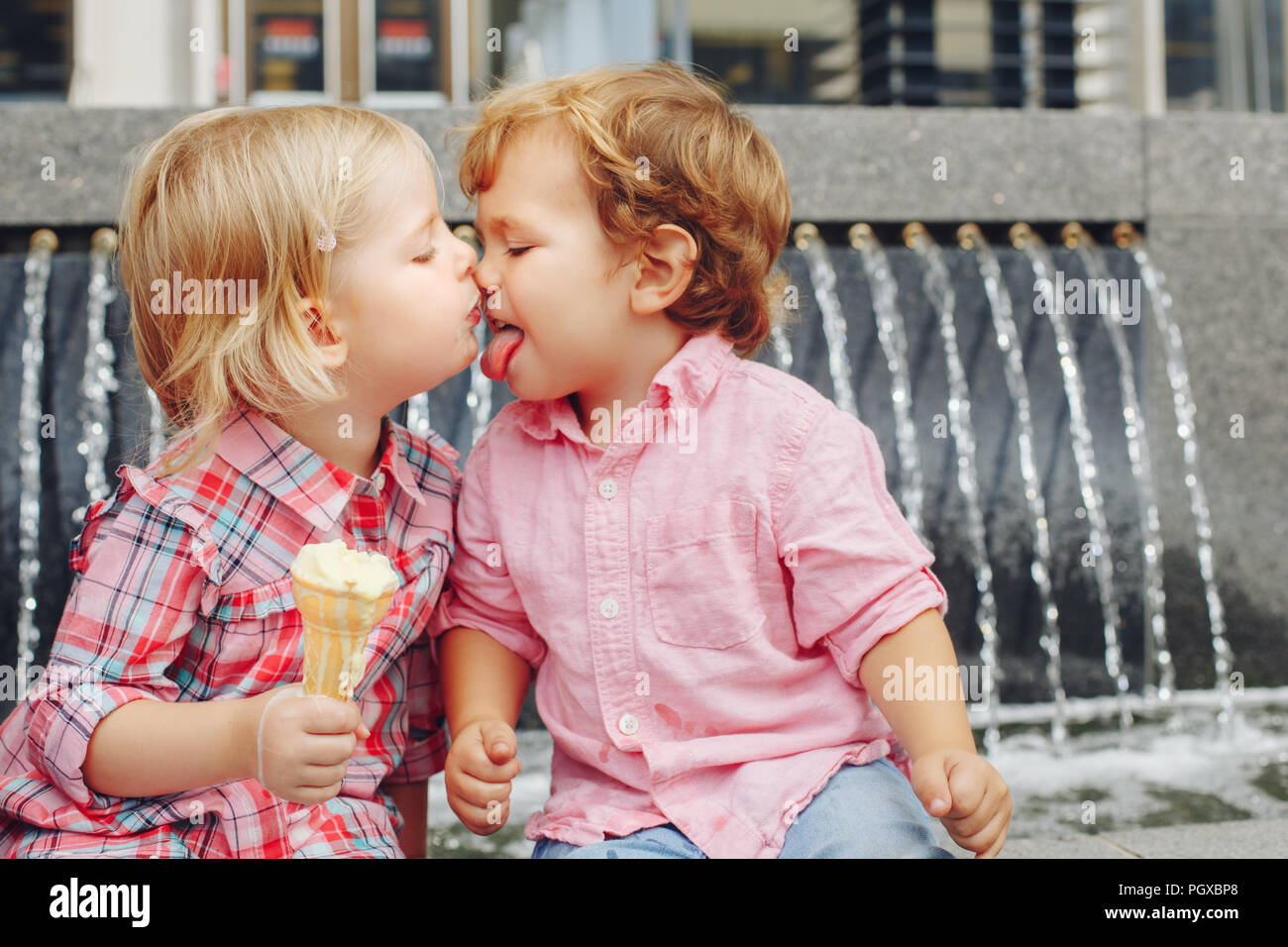 Two children sharing ice cream hi-res stock photography and images - Alamy