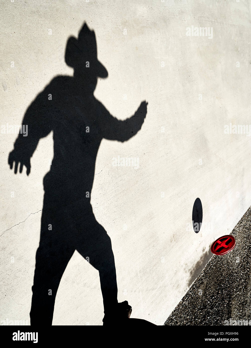 Shadow of a Person throwing a disc reflected on a cement slab Stock ...