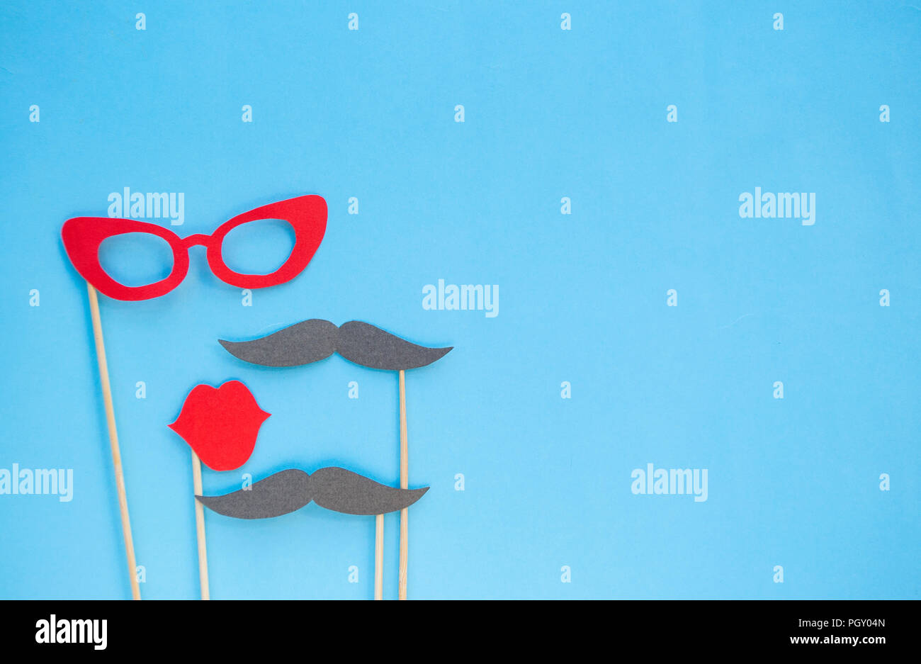Colorful photo booth props glasses, lips and moustaches on blue ...