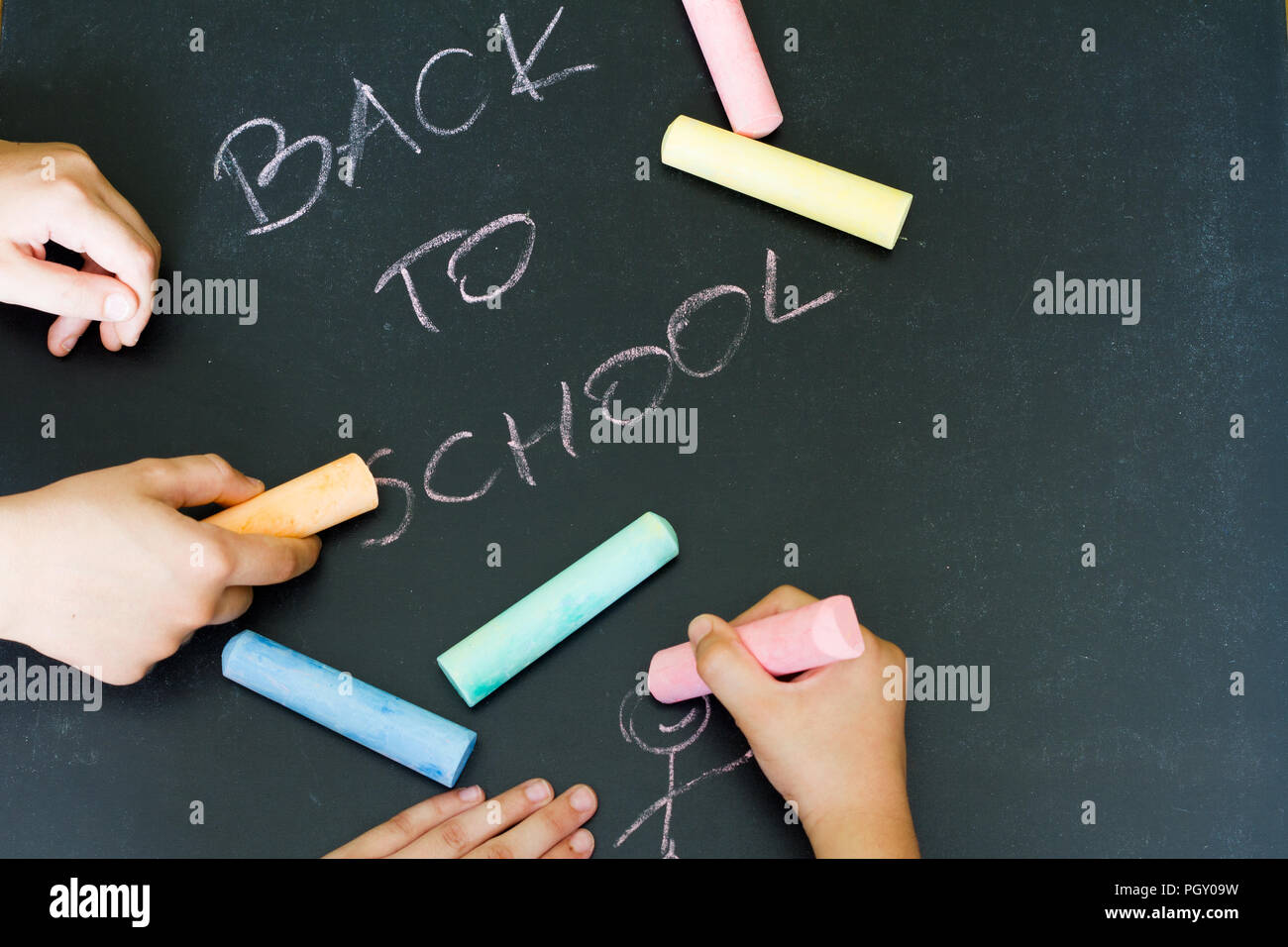 Back to school letters and drawing kids on blackboard Stock Photo - Alamy