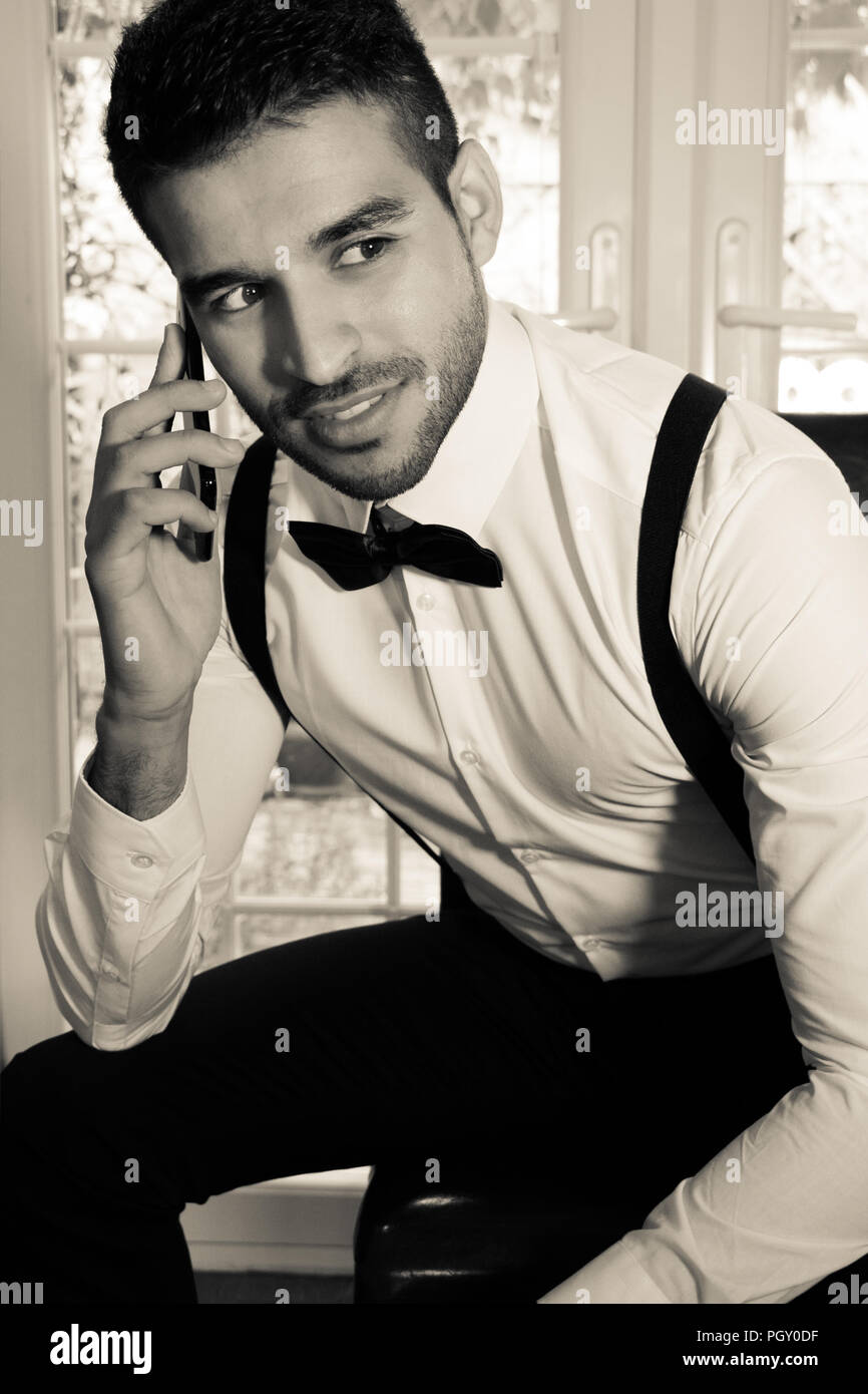 Smiling Professional business man, ceo in tuxedo and bowtie talks on ...