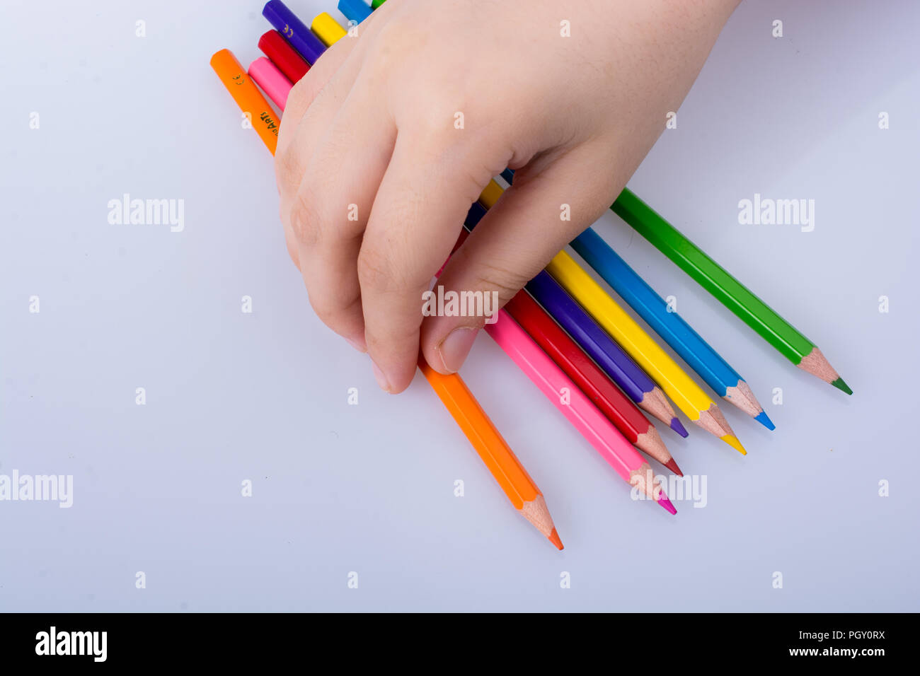 Hand holding color Pencils placed on a white background Stock Photo - Alamy