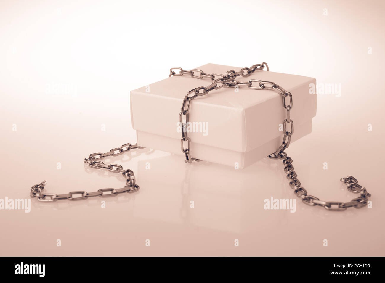 Gift box with a chain around on a white background Stock Photo - Alamy