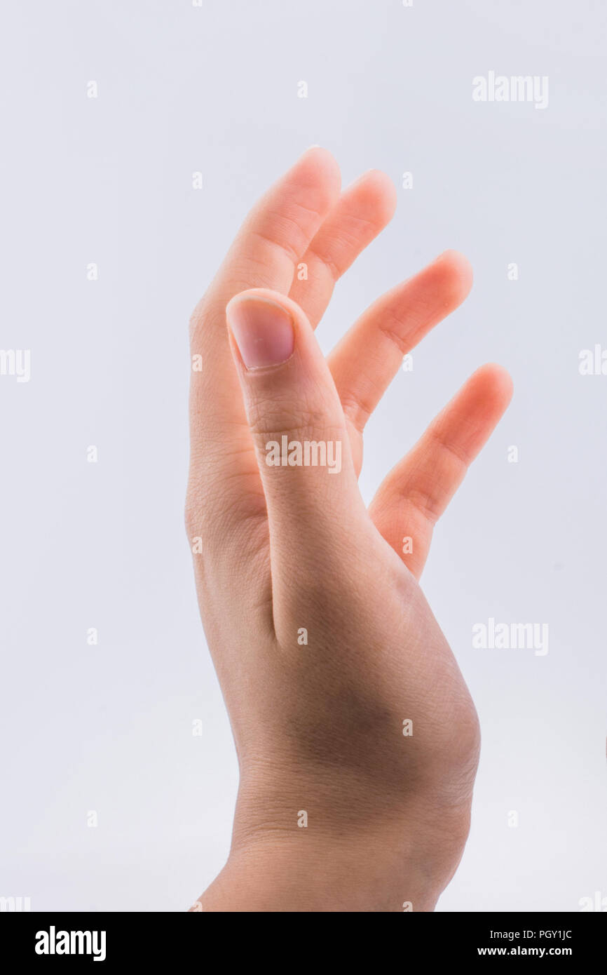 Hand holding gesture made on a white background Stock Photo - Alamy