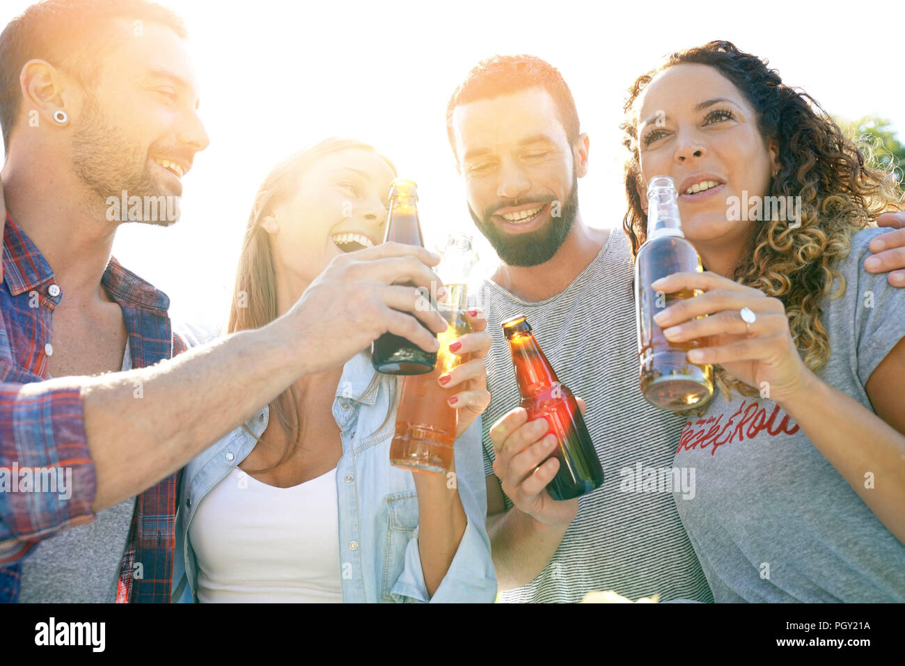 Group of friends gathering in bar drinking beers Stock Photo - Alamy