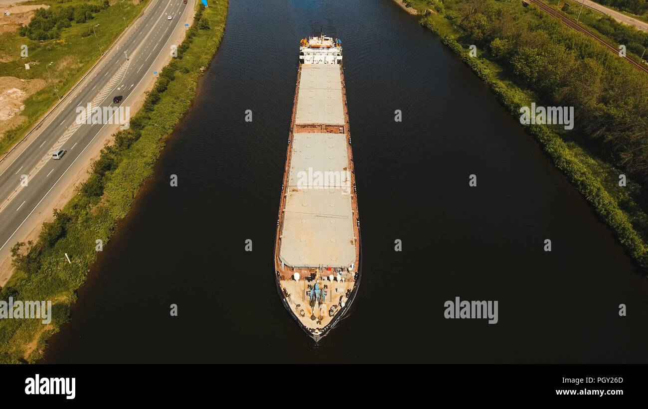 Aerial view:Barge with cargo on the river. River, cargo barge, highway ...