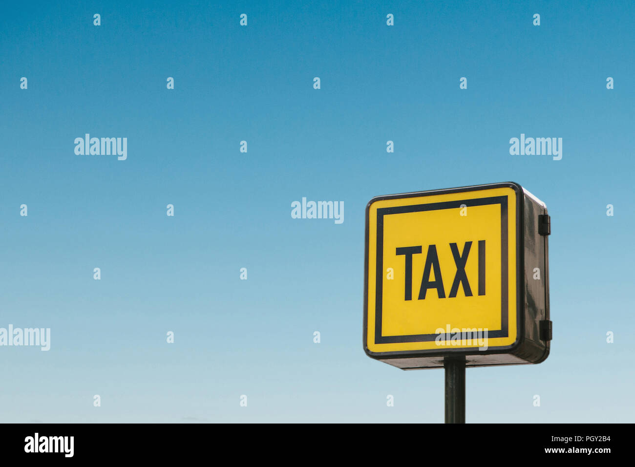 Modern taxi sign against the blue sky Stock Photo - Alamy