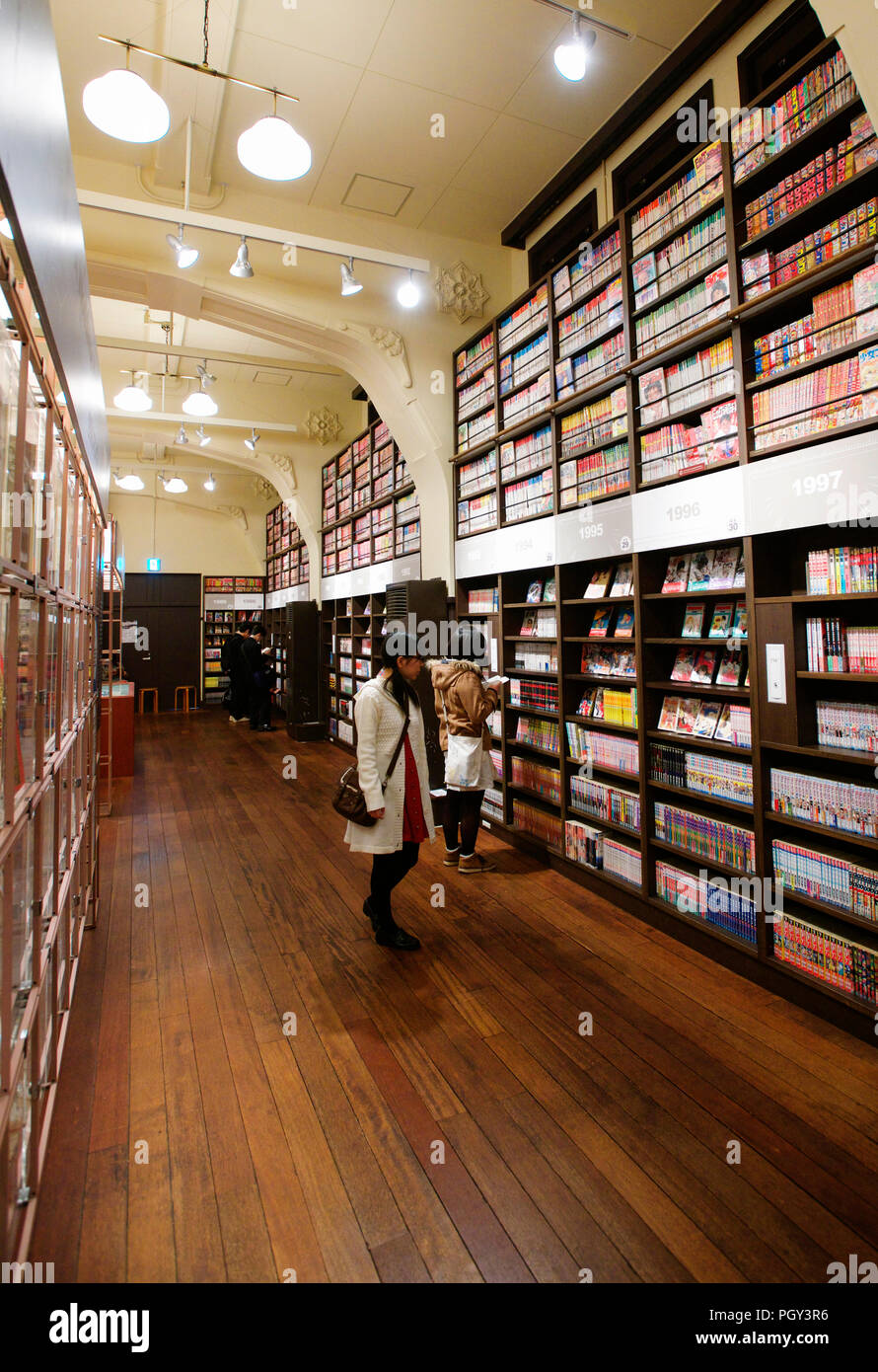 Visitors enjoy reading comics at the Kyoto International Manga Museum ...