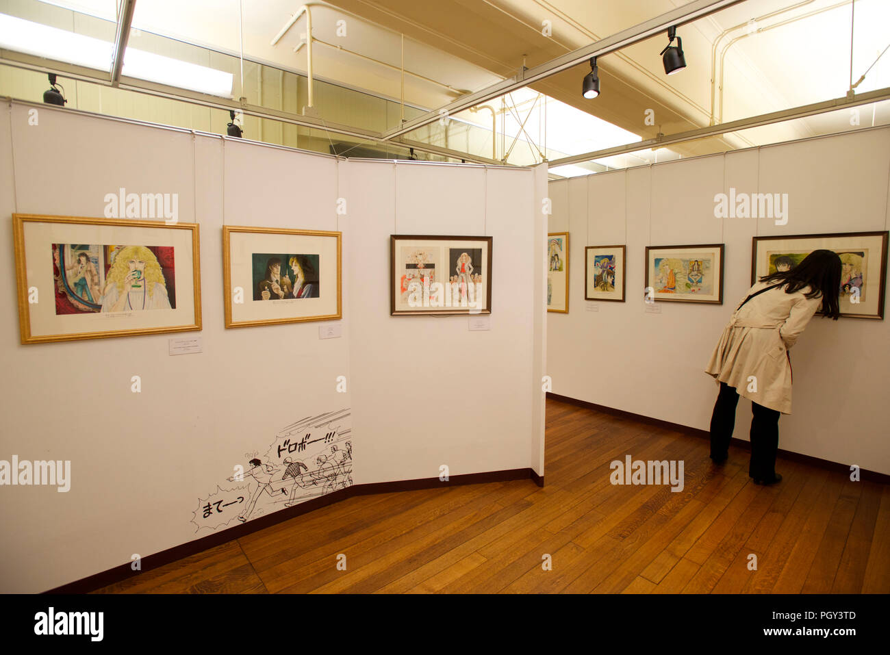 A Visitor enjoy an exhibition of a manga artist's work on display at ...