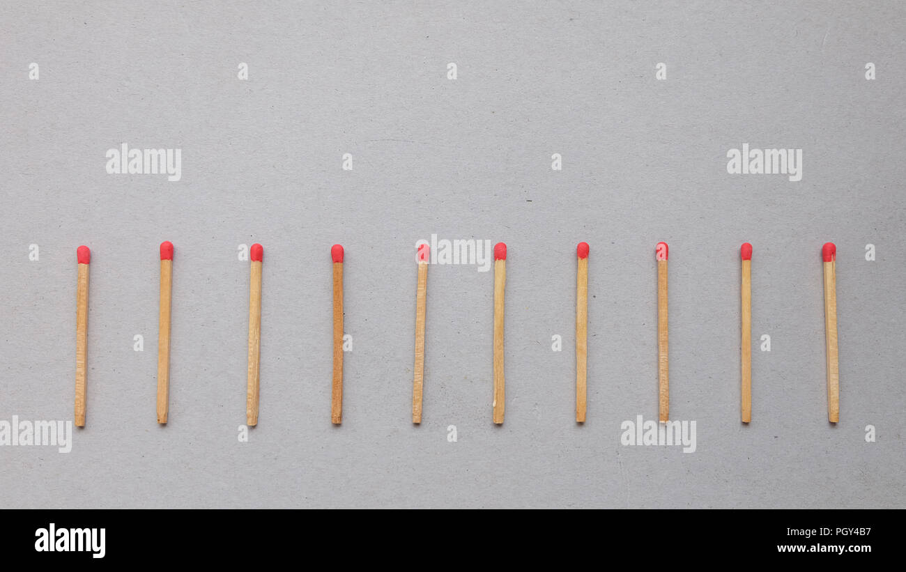 Flat lay of matches in a straight line on a gray background Stock Photo ...