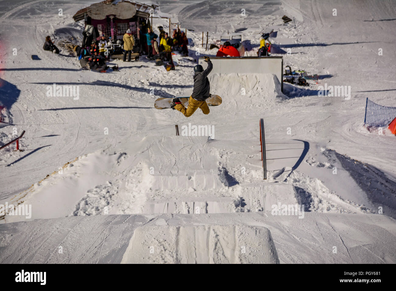 A freestyle snowboarder makes a backside air grab Stock Photo - Alamy