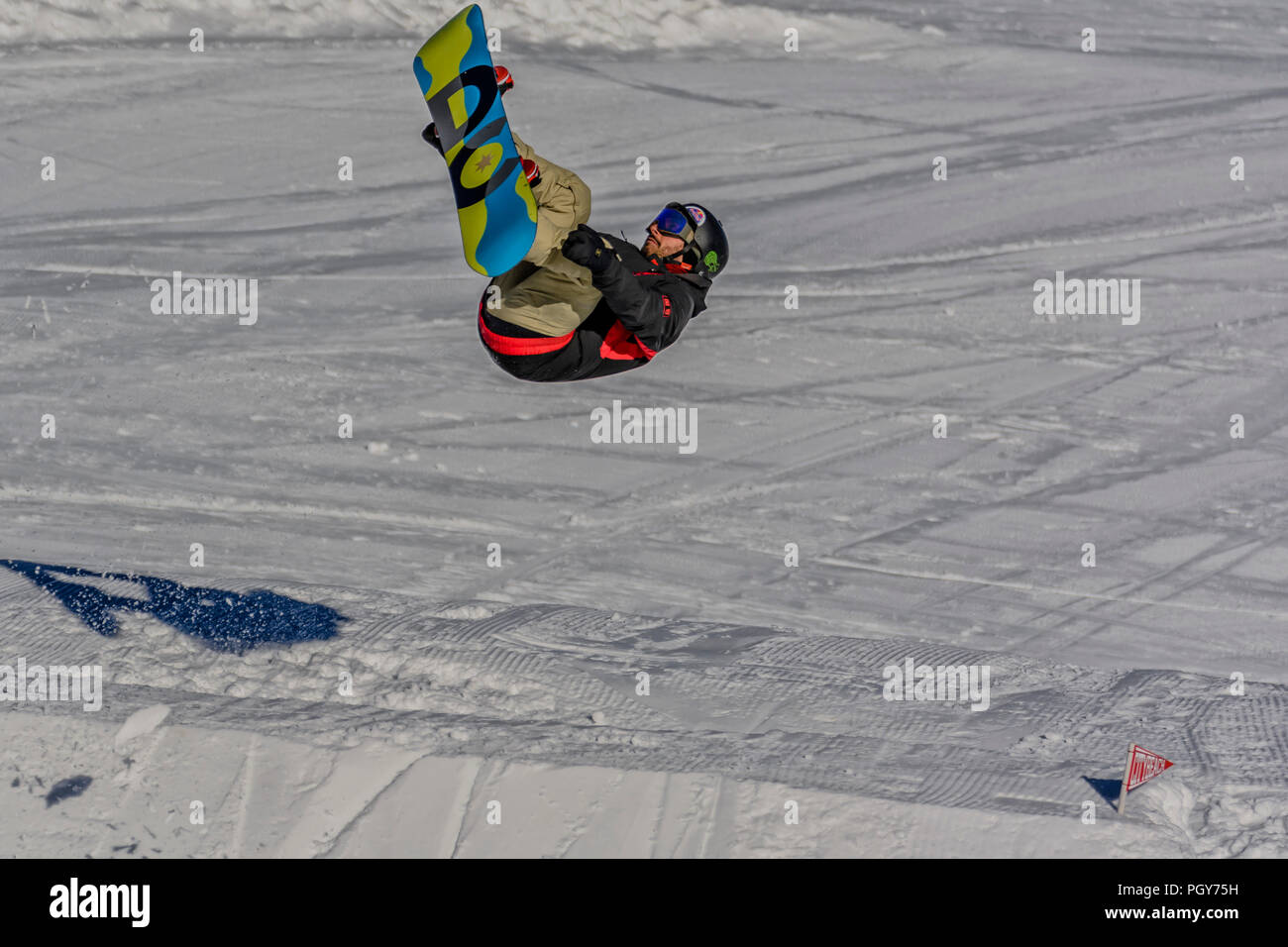 A freestyle snowboarder is performing a rodeo flip Stock Photo - Alamy