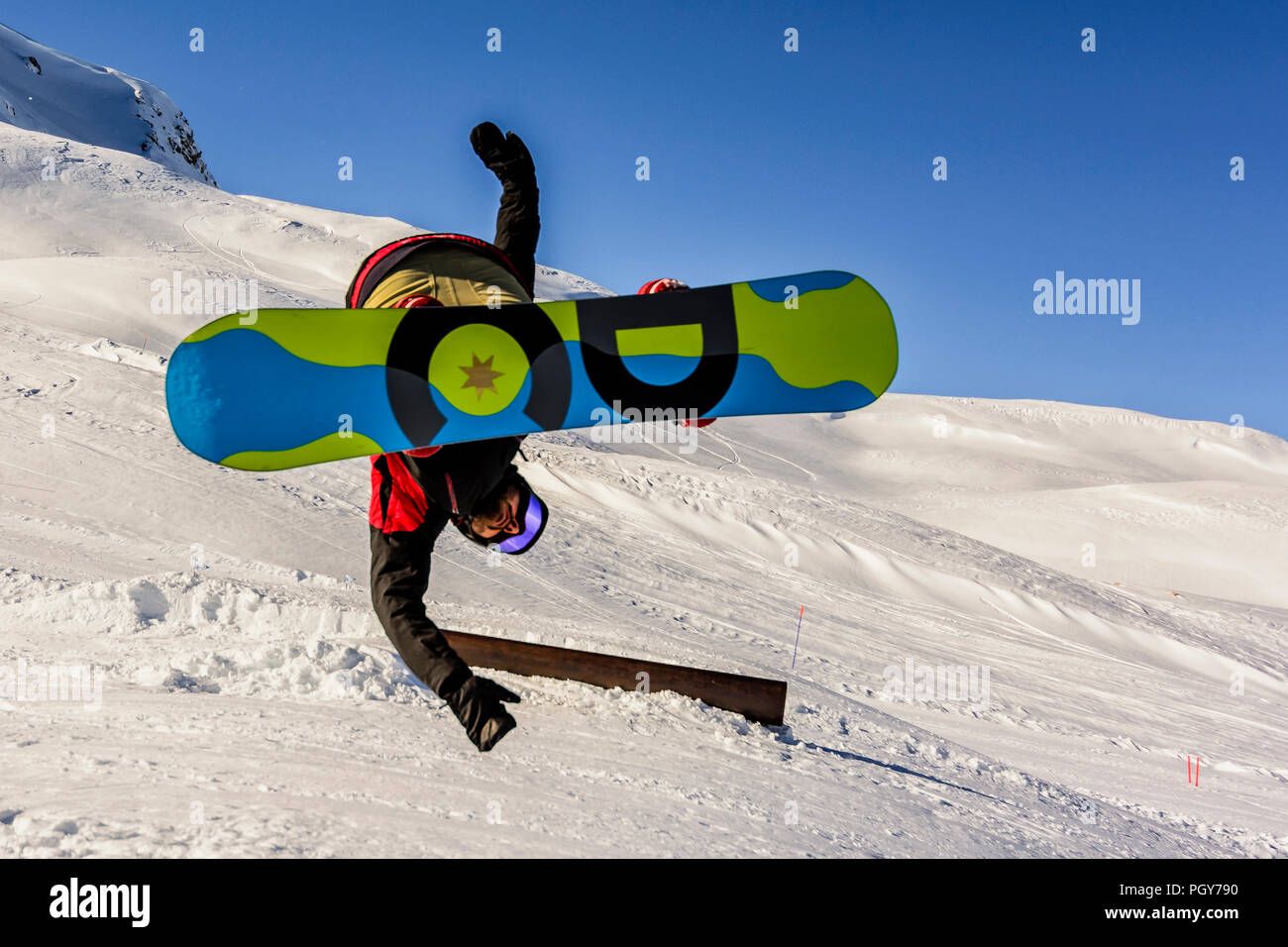 A freestyle snowboarder is performing a rodeo flip Stock Photo - Alamy