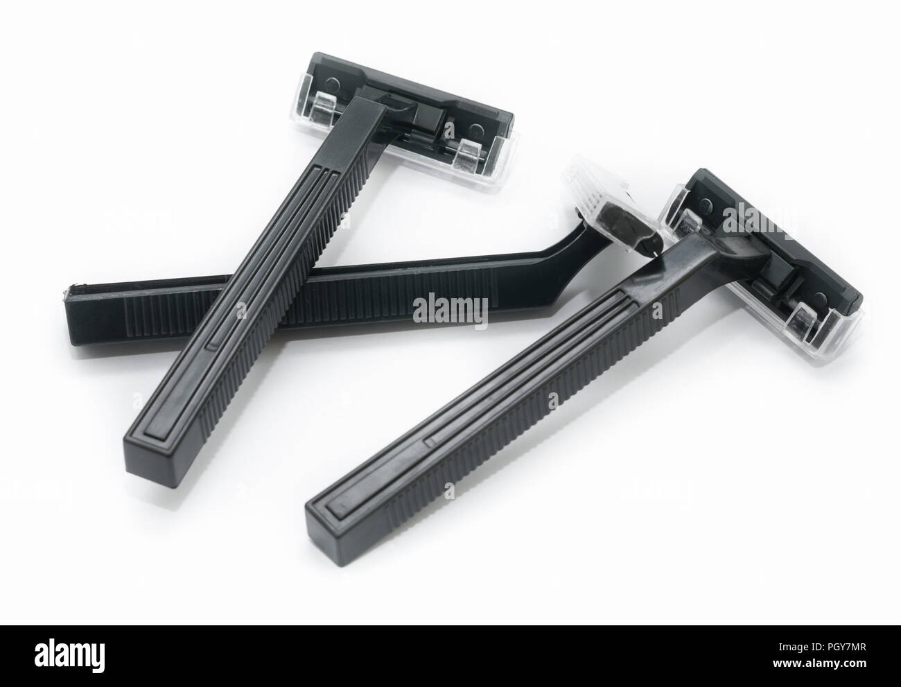 Three new black plastic disposable razors on isolated white background ...