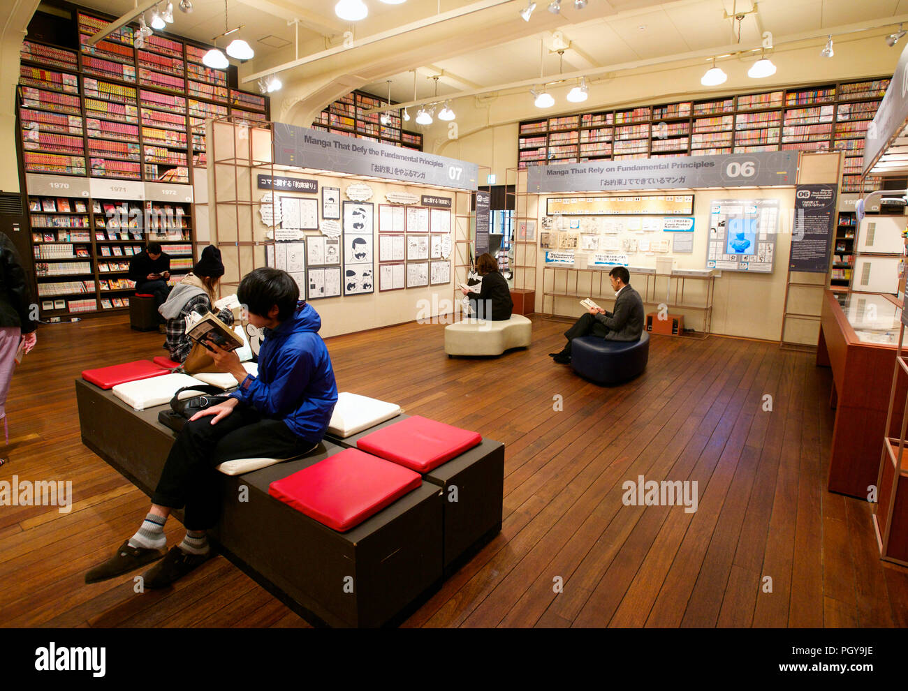 Visitors enjoy reading comics at the Kyoto International Manga Museum ...