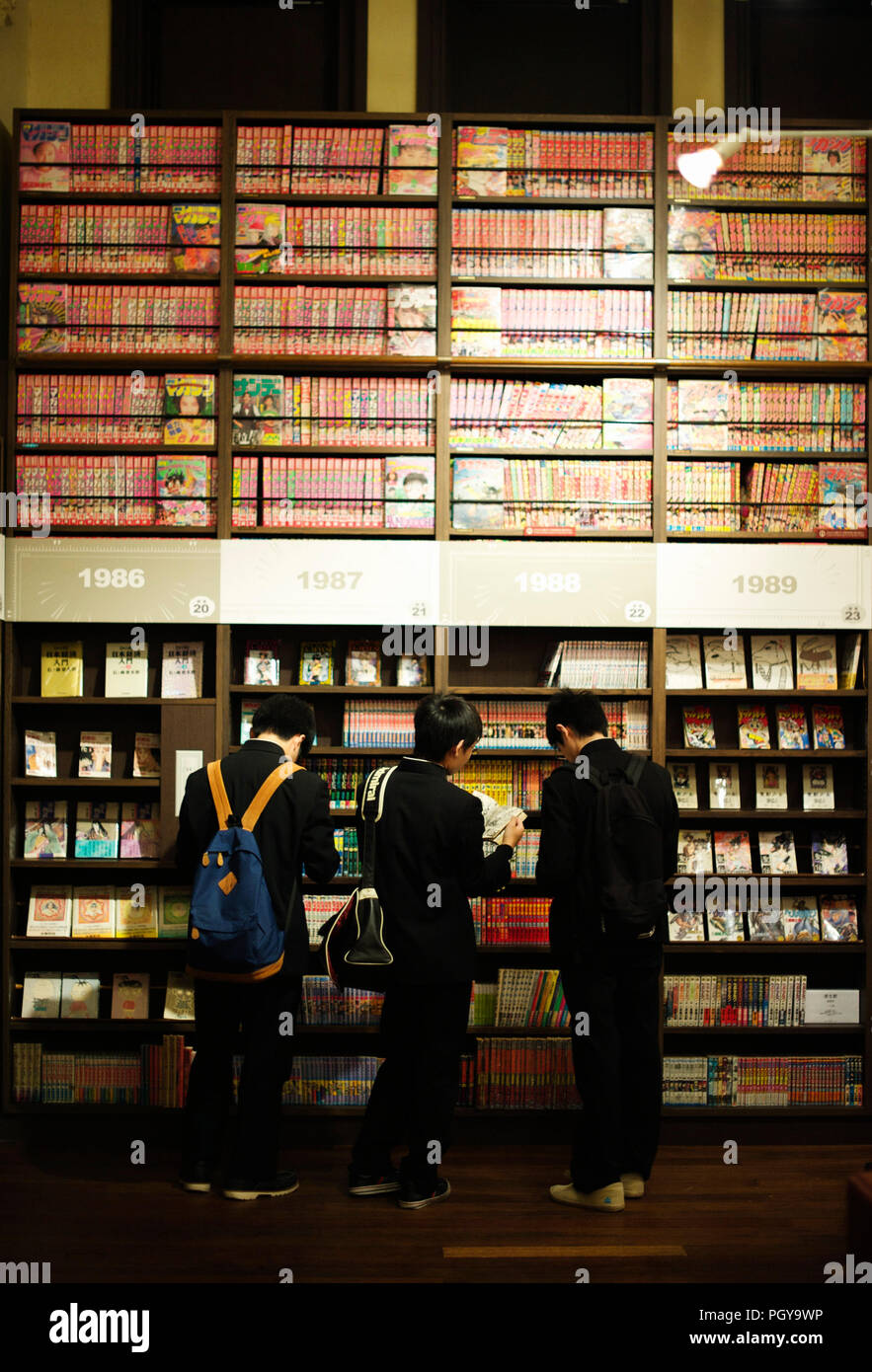 Visitors enjoy reading comics at the Kyoto International Manga Museum ...