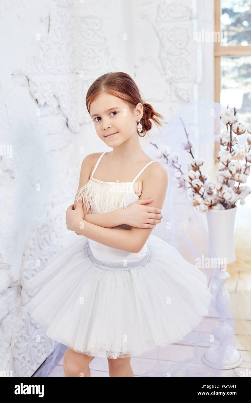 Young ballerina girl is preparing for a ballet performance. Little ...