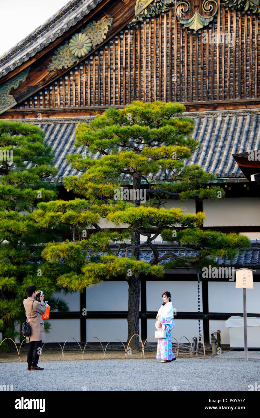 A woman has her photo taken outside one of the main buildings of the ...