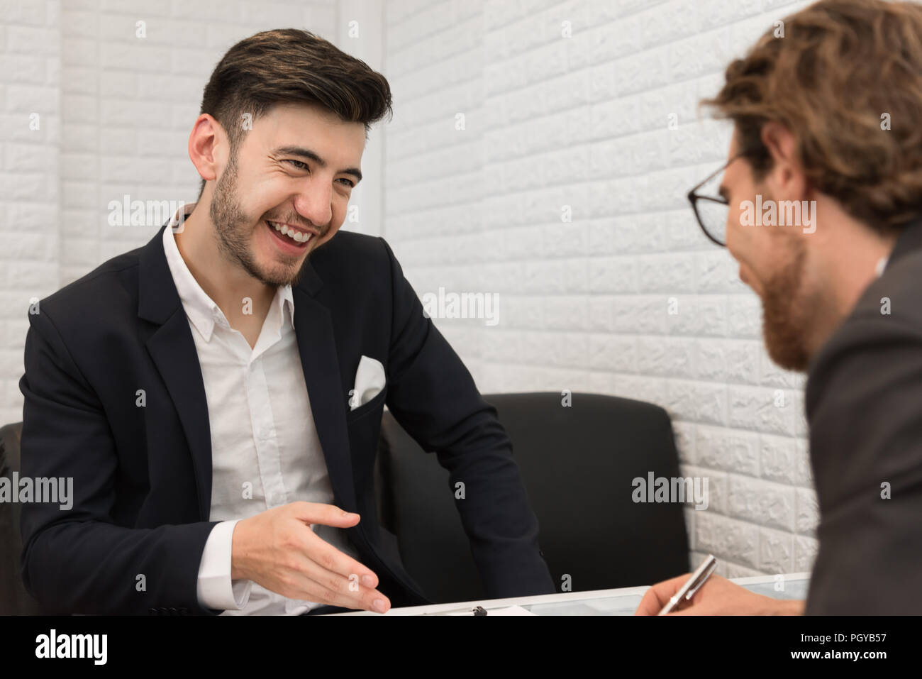 Two businessmen are negotiating a trade agreement together. Business ...