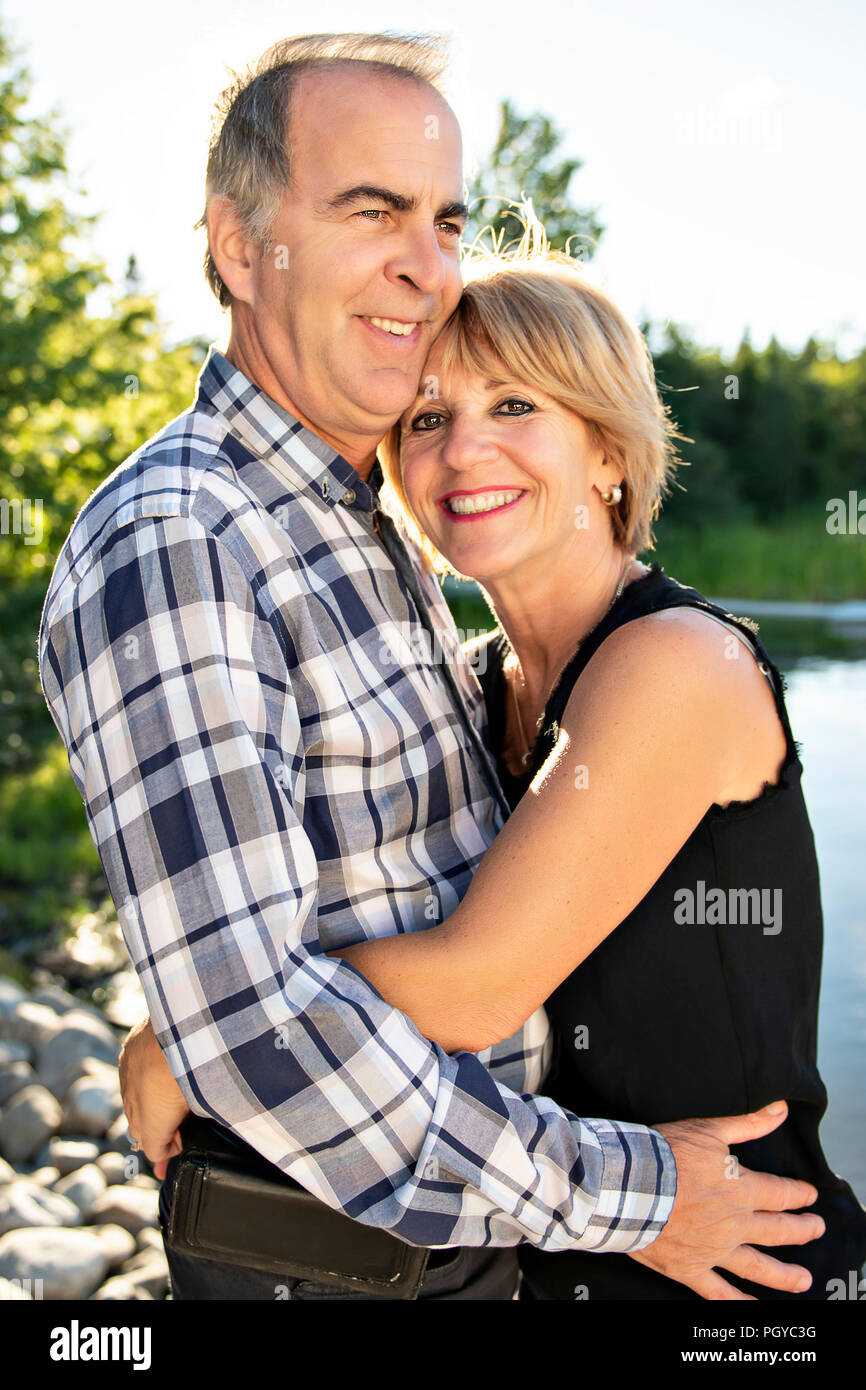 A Couple outdoors by lake having good time Stock Photo - Alamy