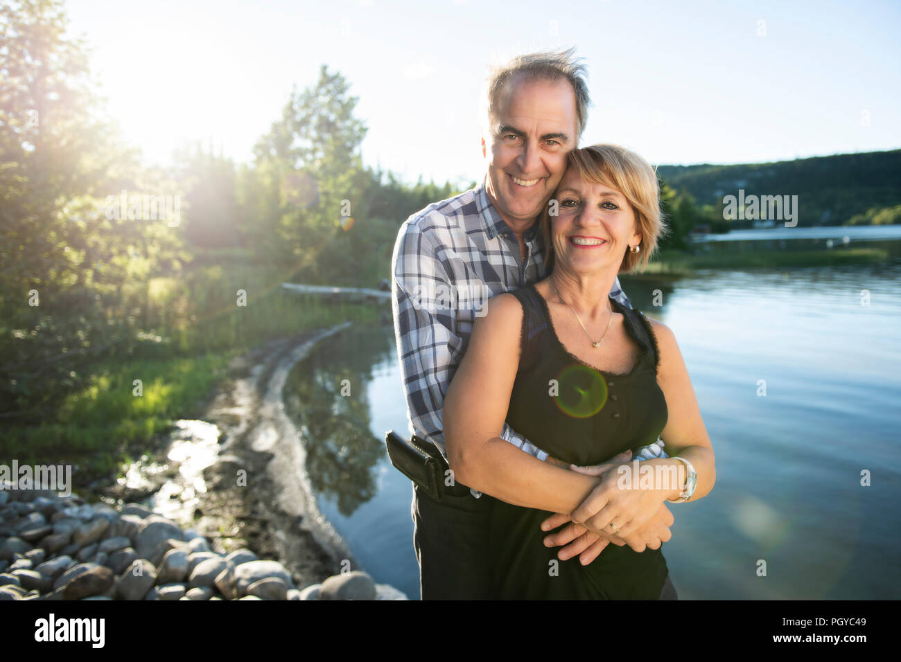 A Couple outdoors by lake having good time Stock Photo - Alamy